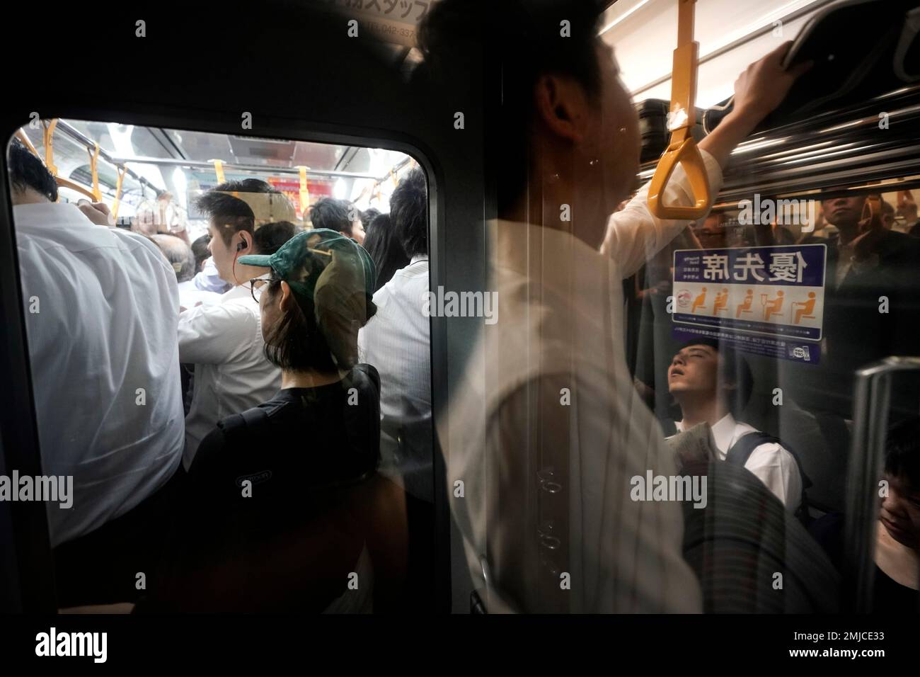 In this July 30, 2019, photo, commuters travel in an overcrowded train ...