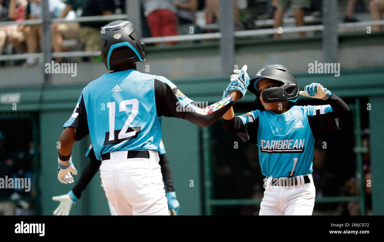 Curacao's Curley Martha (12) is greeted at home plate by Zion Pardo (1 ...
