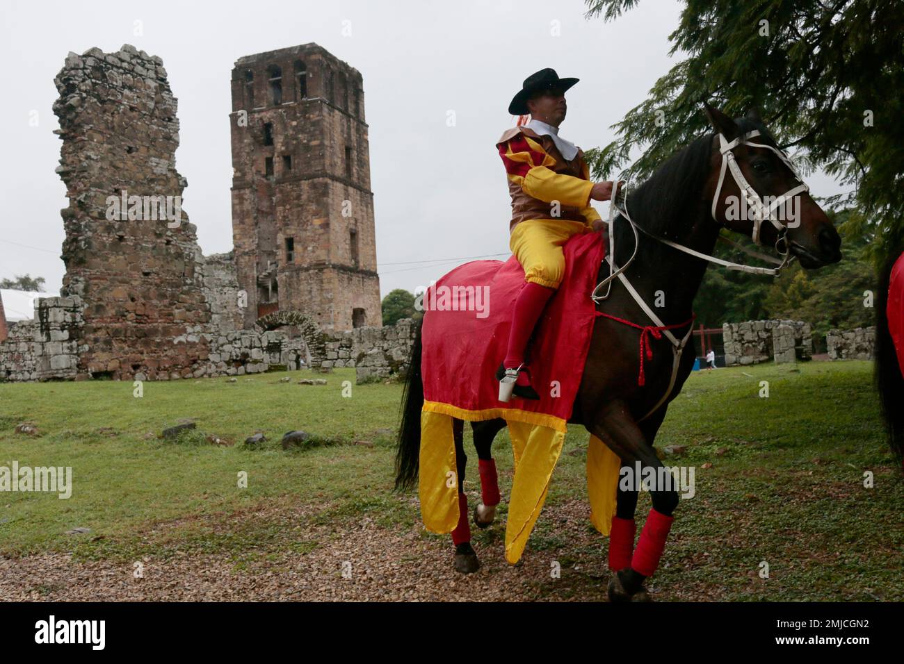 A man dressed as old colonial Spaniard rides a horse during the ...
