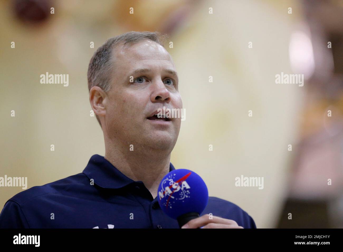 NASA Administrator Jim Bridenstine talks to reporters in front of the ...