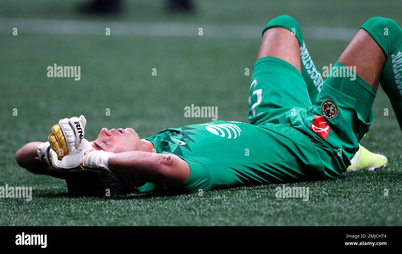 Club America goalkeeper Oscar Jimenez (27) lies on the pitch after ...