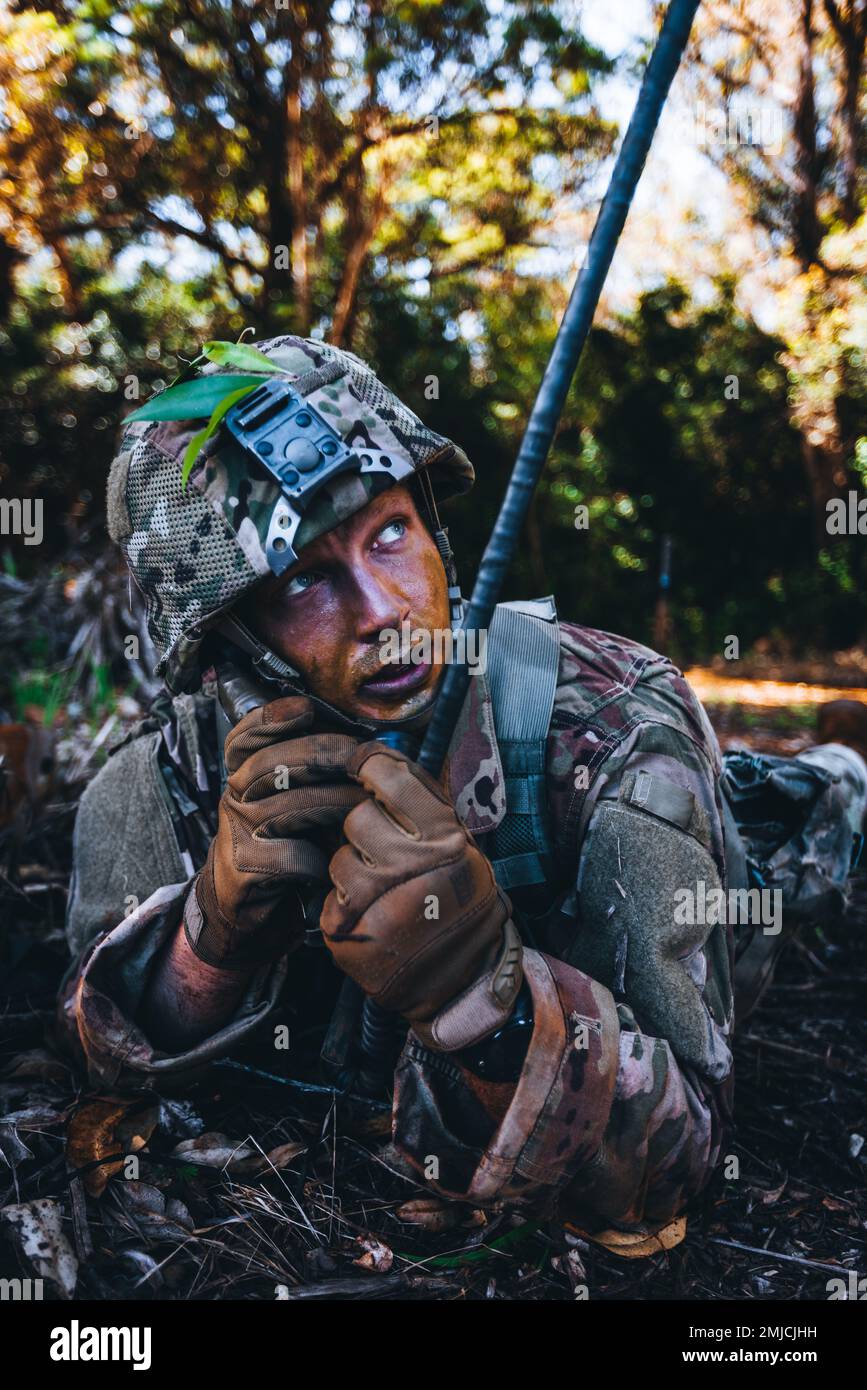 U.S. Soldier calls back to his squad during an ambush exercise while at ...
