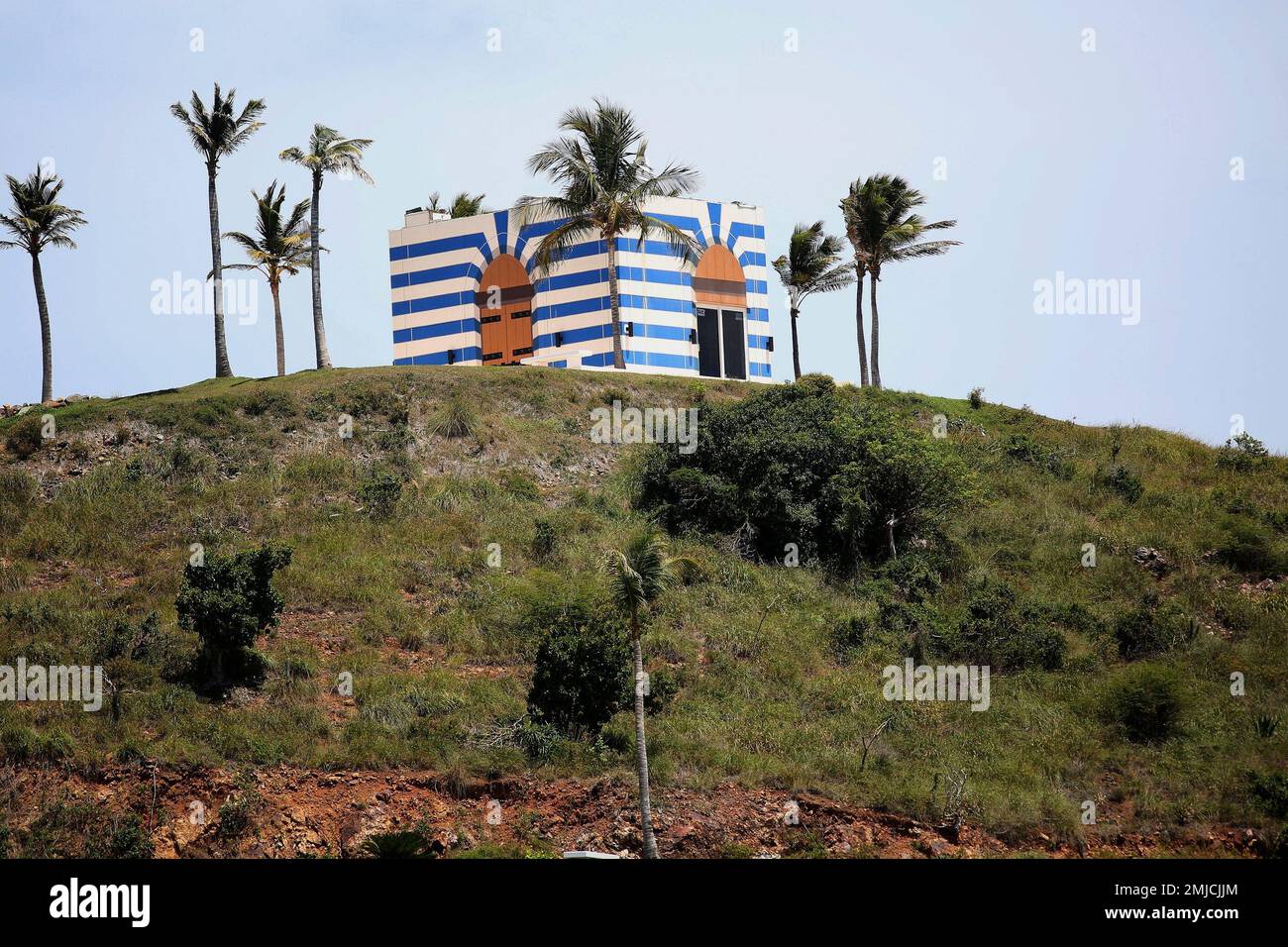 A blue-striped structure sits on a lookout point on Little St. James ...