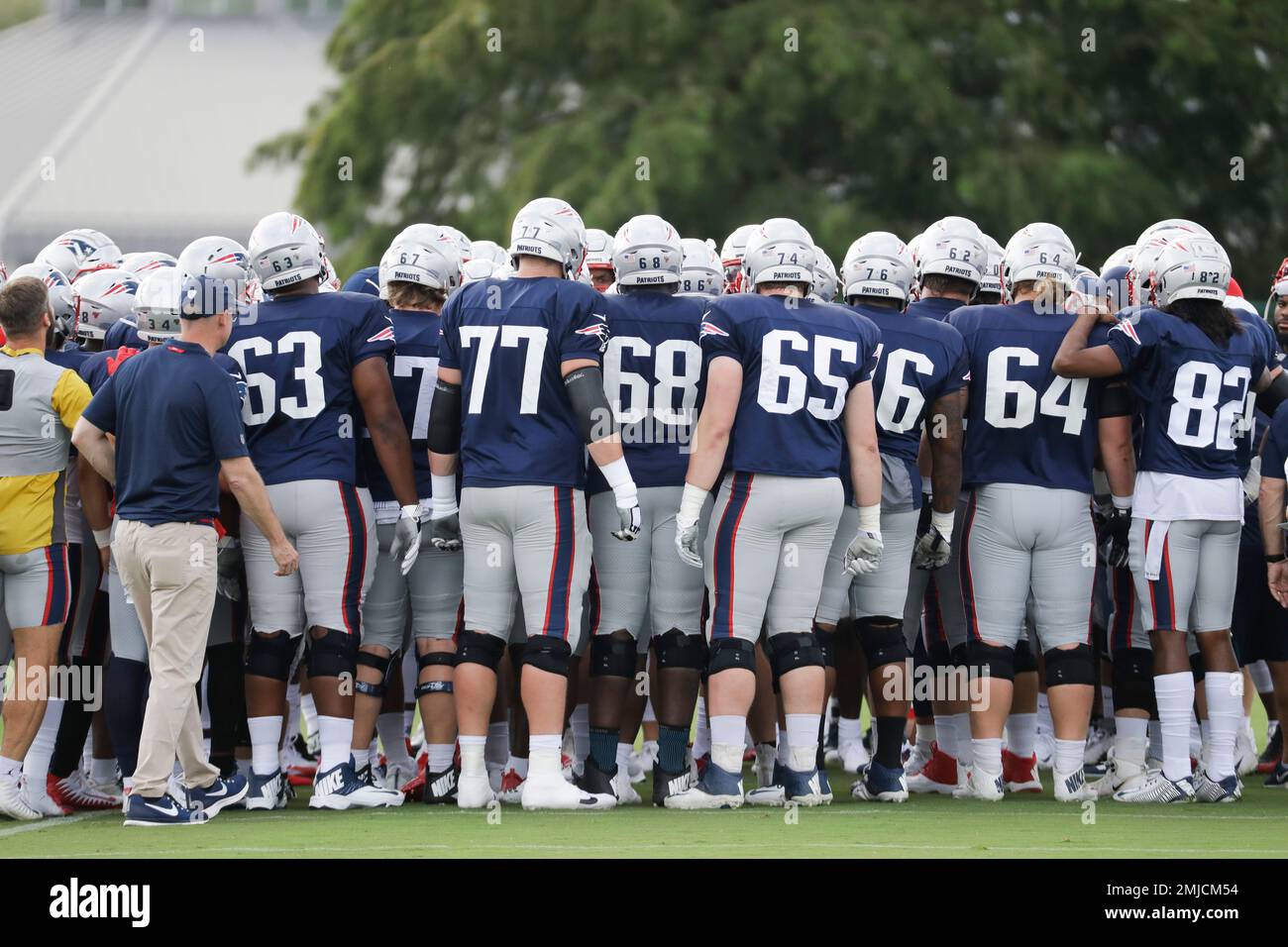 New England Patriots players and coaches gather together during a ...