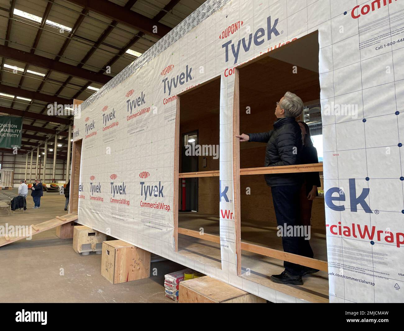 Oregon Gov. Tina Kotek examines a mass timber affordable housing ...