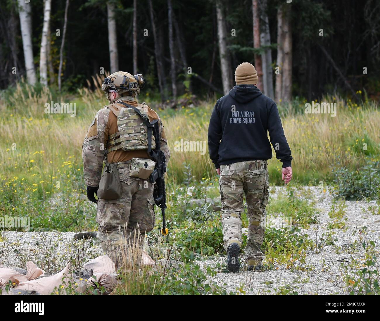 Soldiers from the 65th Explosive Ordnance Disposal Company inspect a ...