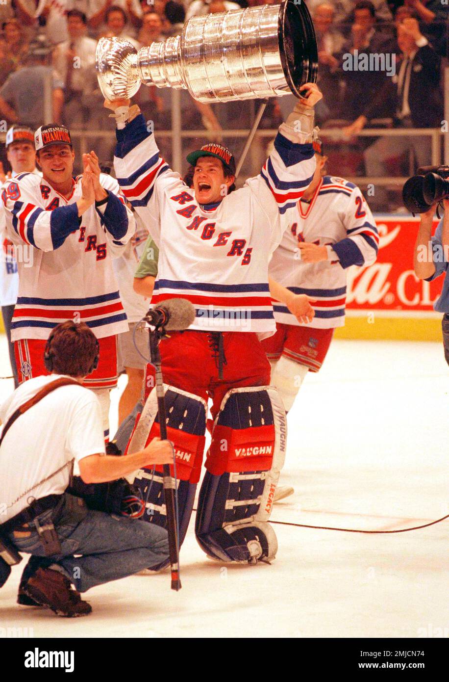 New York Rangers goalie Mike Richter holds up the Stanley Cup after his ...