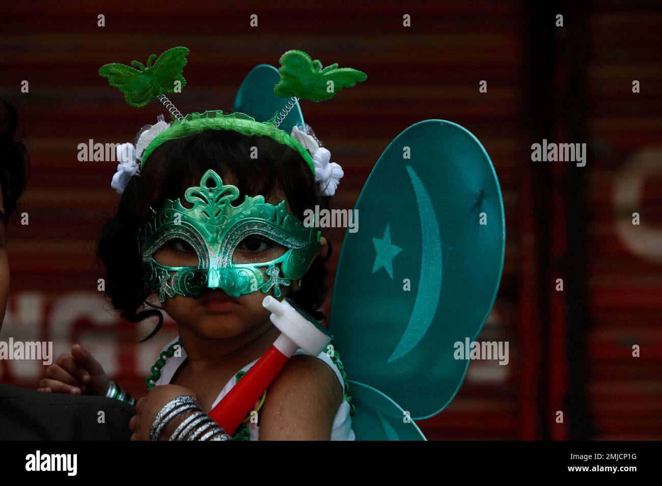 A Pakistani girl wears mask to celebrate Independence Day, in Peshawar ...