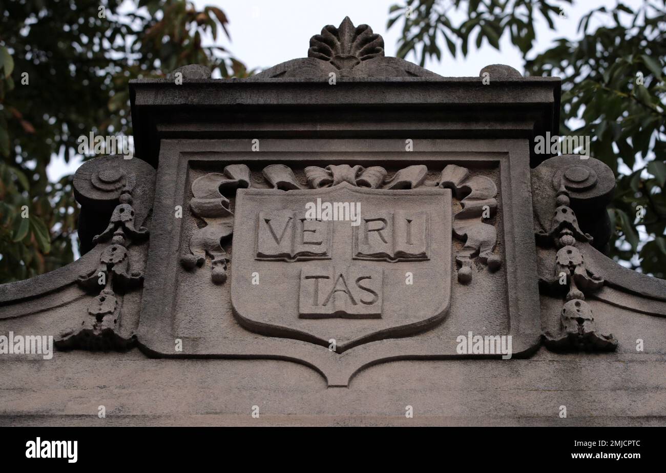 The motto "Veritas" on a gate of Harvard Yard at Harvard University in ...
