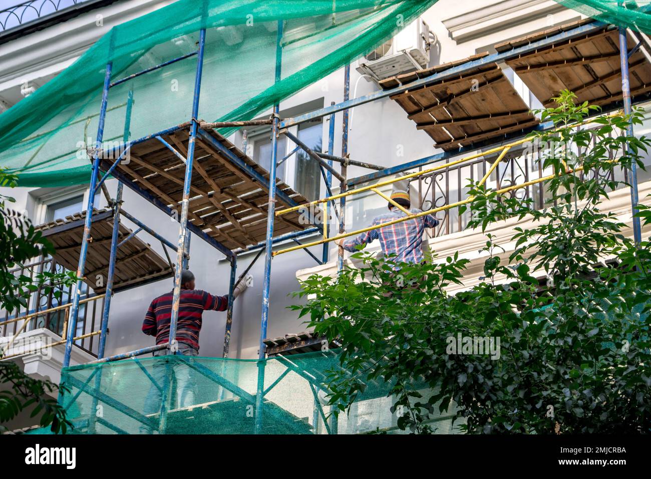 Repair and painting of building facade, restoration Stock Photo - Alamy