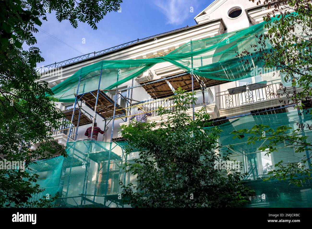 Repair and painting of building facade, restoration Stock Photo - Alamy
