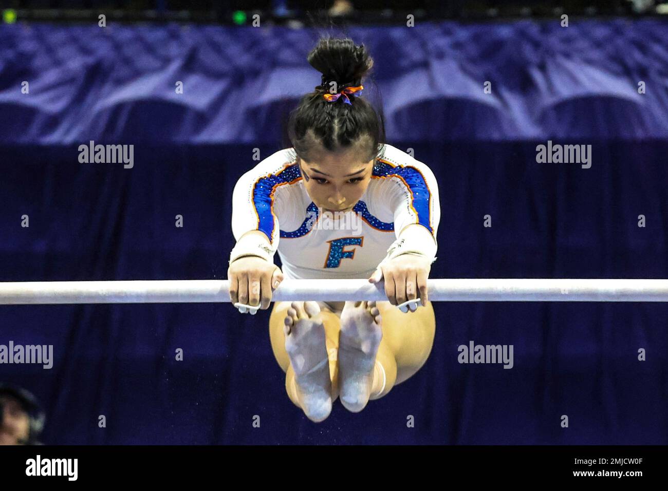 Florida's Victoria Nguyen competes on the uneven bars during an NCAA ...