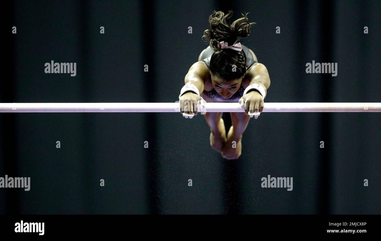 Simone Biles practices on the uneven bars for the senior women's ...
