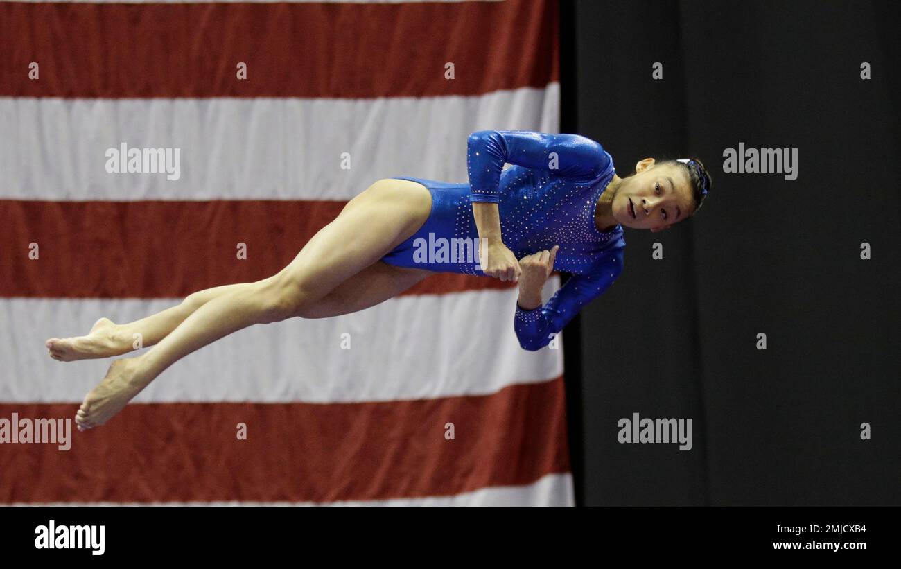 Leanne Wong competes on the beam during the senior women's competition ...