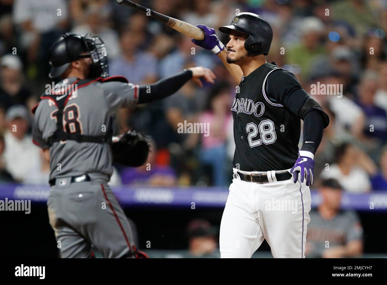 Colorado Rockies' Nolan Arenado, right, reacts after striking out as ...