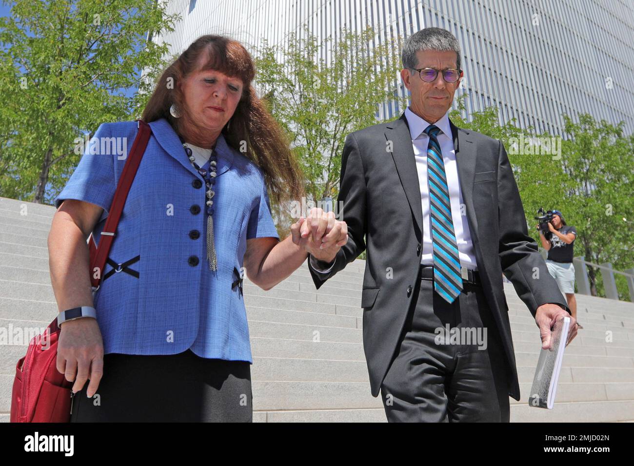 Mike and Becky Shamo, the parents of Aaron Shamo, walk from the federal ...