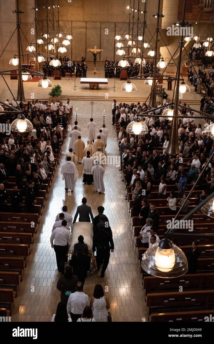 LOS ANGELES, CALIF. -- MONDAY, AUGUST 12, 2019: Pallbearers carries ...