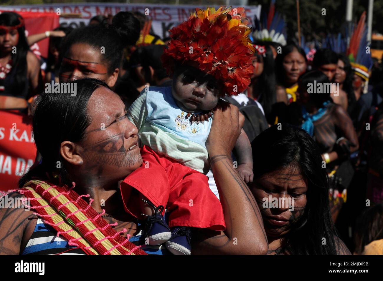 An indigenous mother carries her son during during the Indigenous Women ...