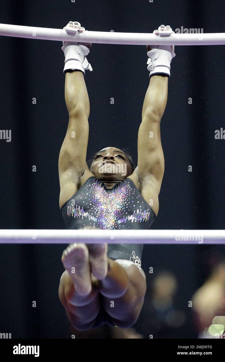 Simone Biles practices on uneven bars for the senior women's ...