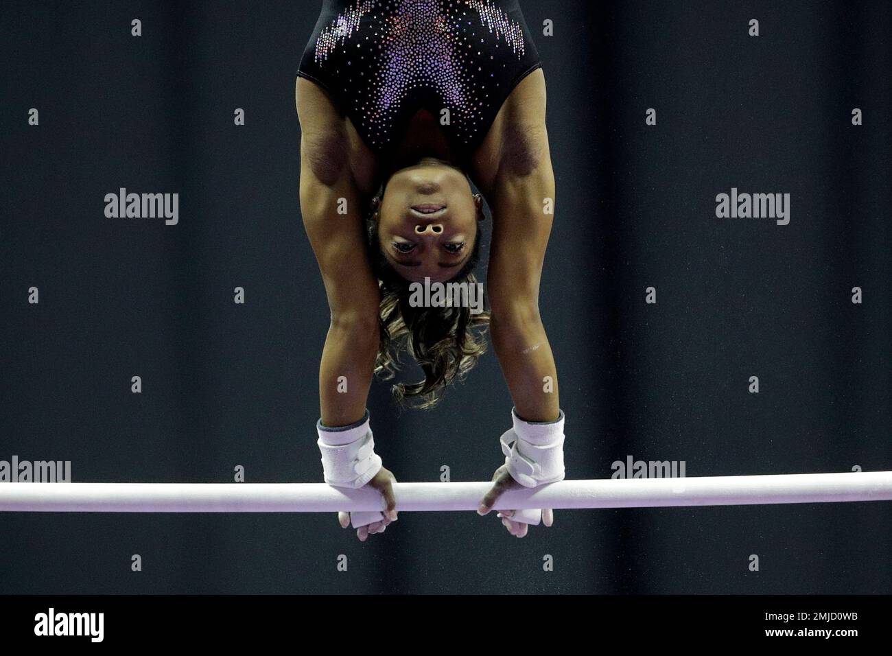 Simone Biles practices on uneven bars for the senior women's ...