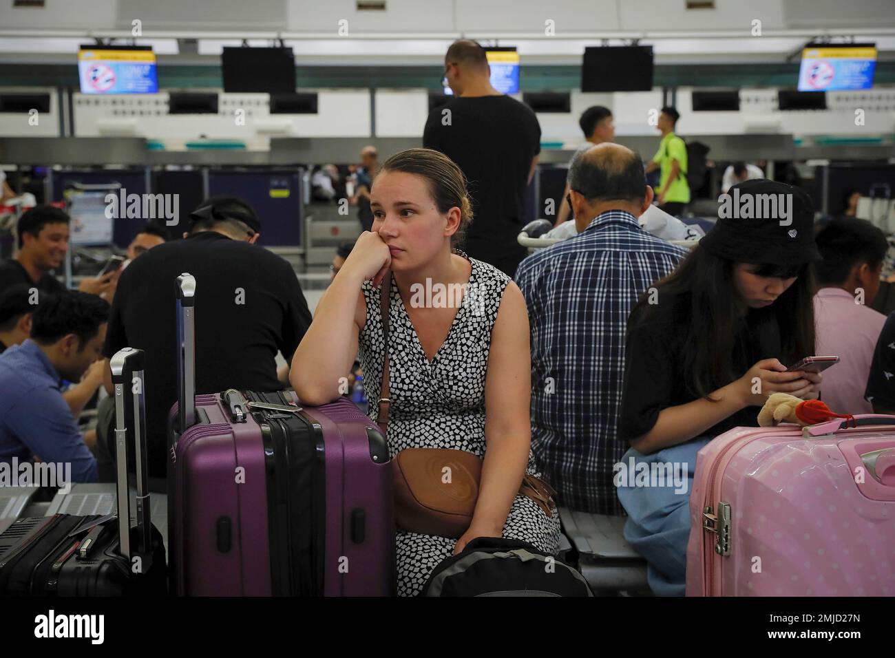 Australian Penny Tilley, center, reacts next to stranded travelers at ...