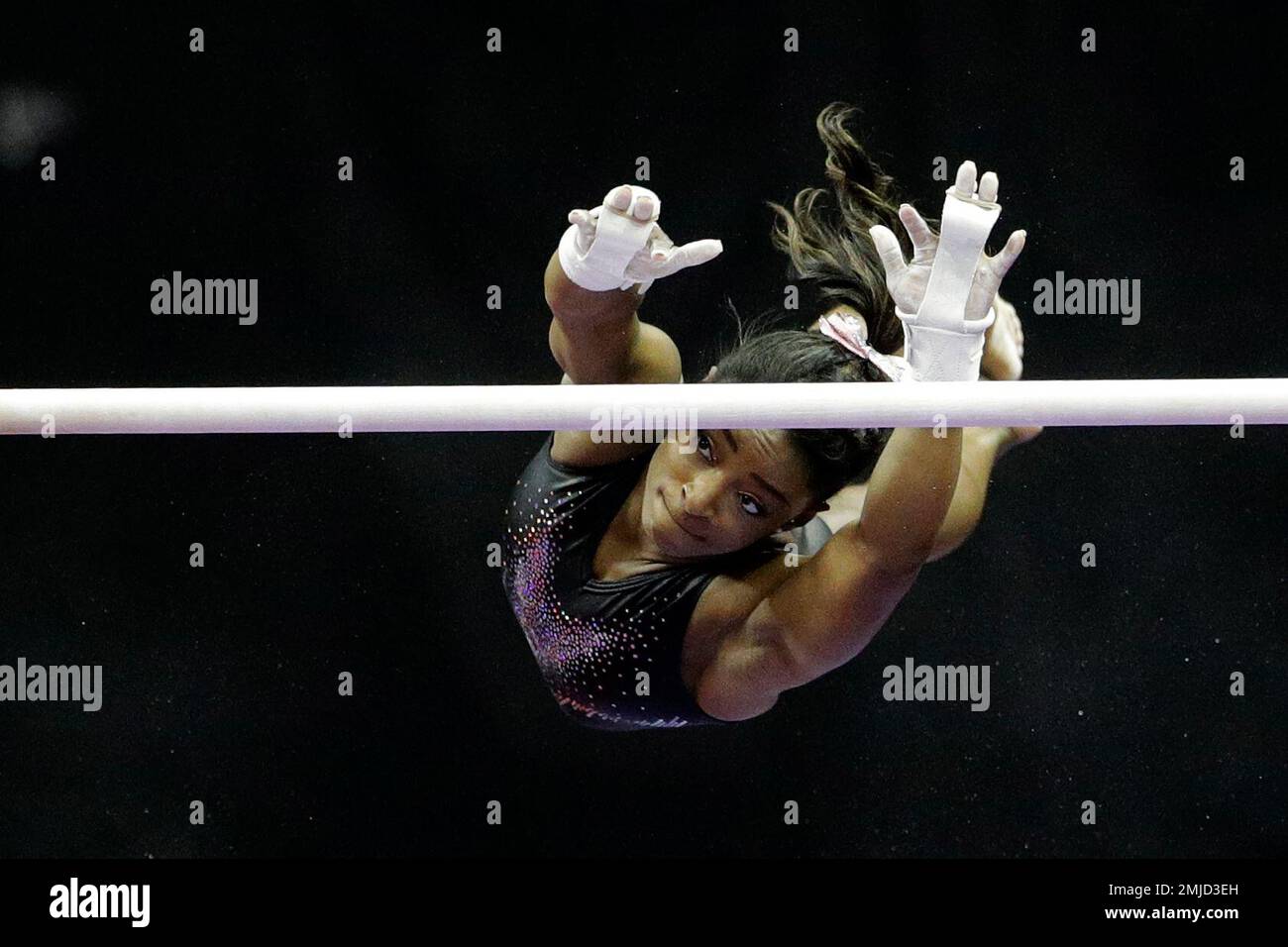 Simone Biles practices on the uneven bars for the senior women's ...