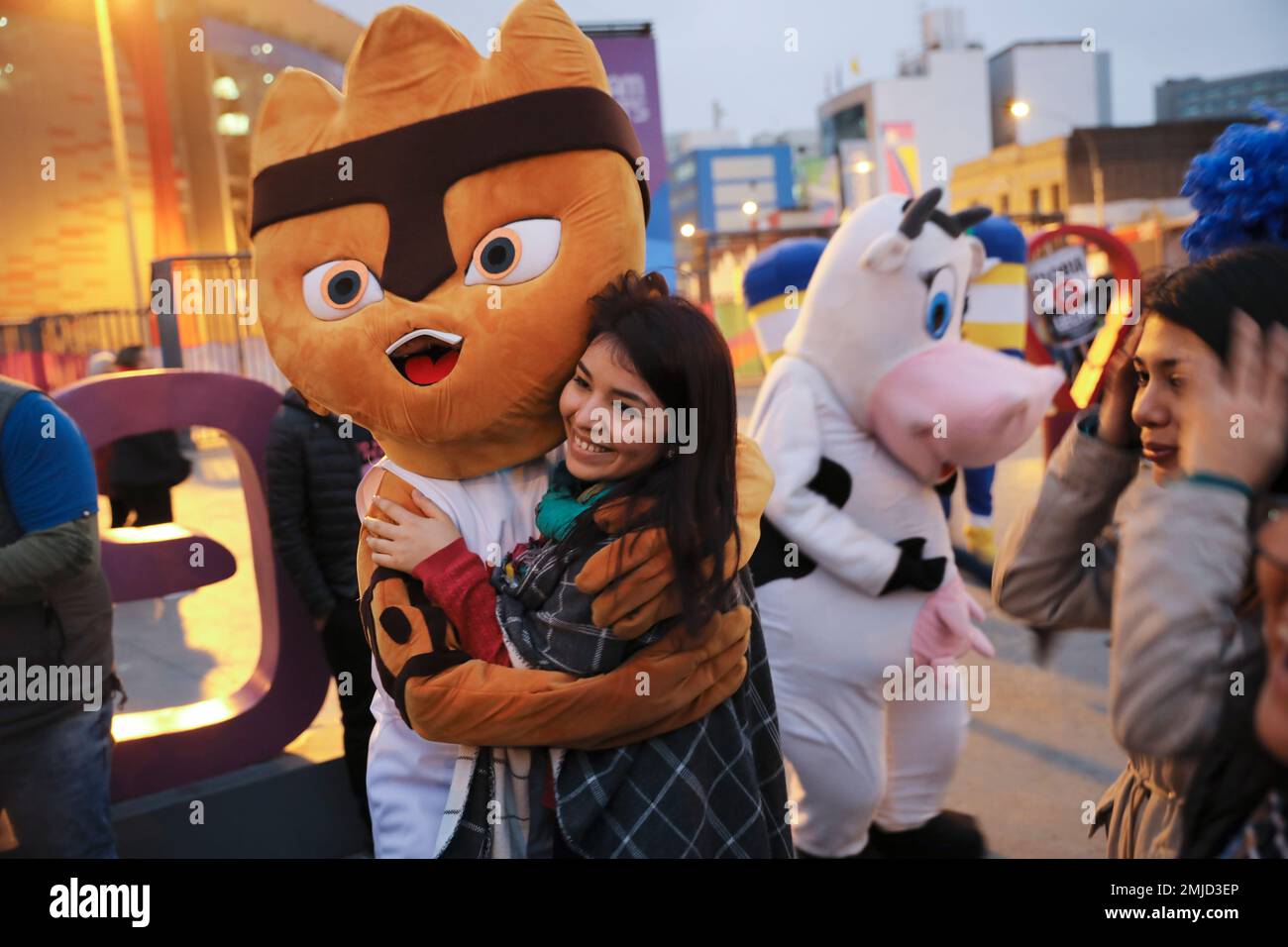 Milco, the official mascot of the Pan American Games, embraces a ...