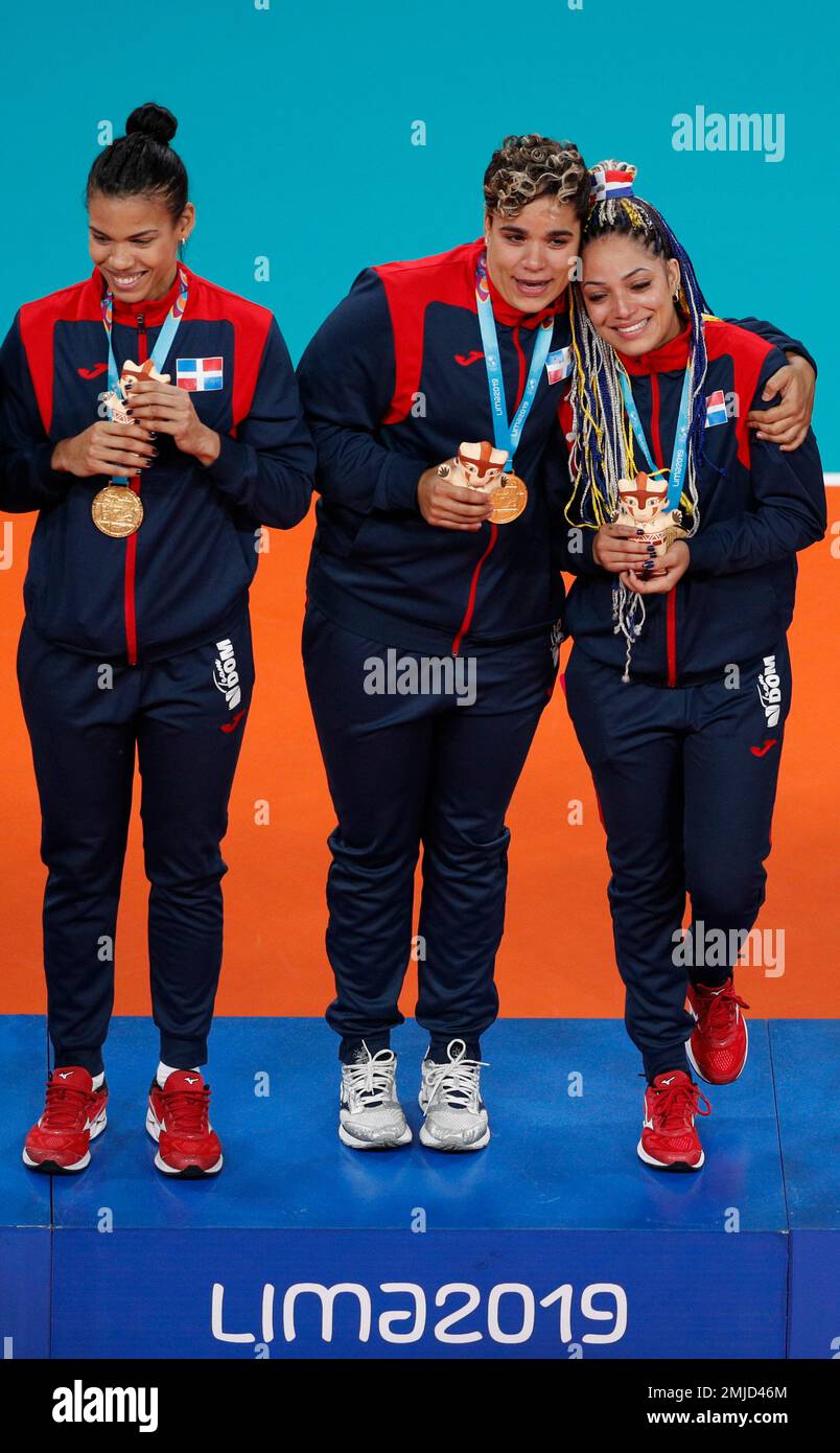 Members of the Dominican Republic's women's volleyball team embrace as ...