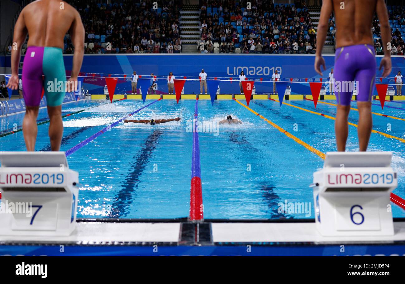 Competitors from the teams of Colombia, left, and Paraguay swim in the ...