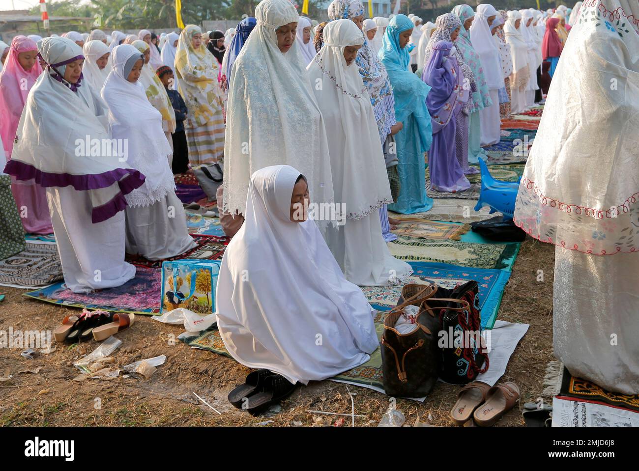 Muslim women perform during a morning prayer marking Eid al-Adha ...