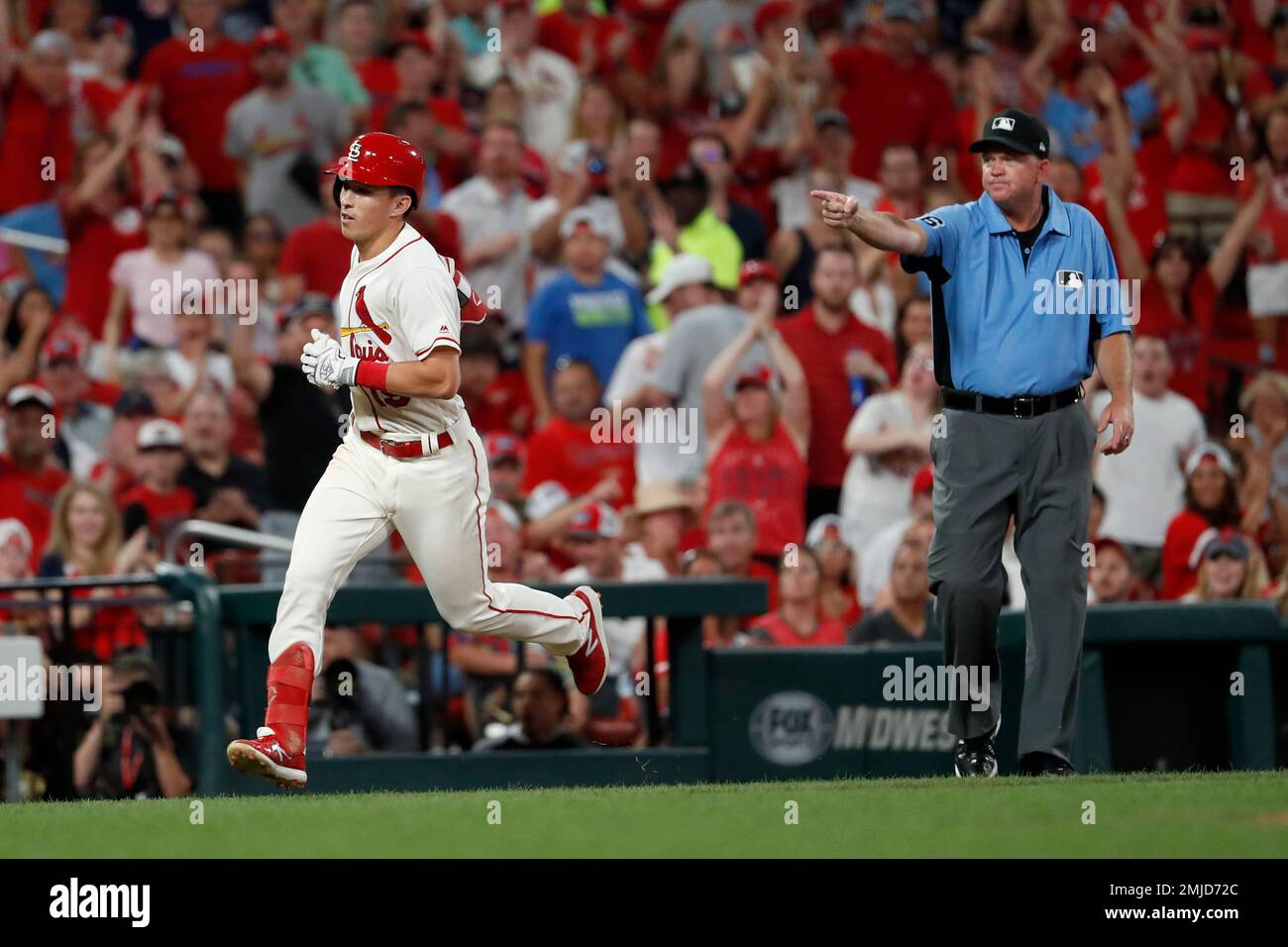 Third base umpire Ron Kulpa, right, motions for St. Louis Cardinals ...