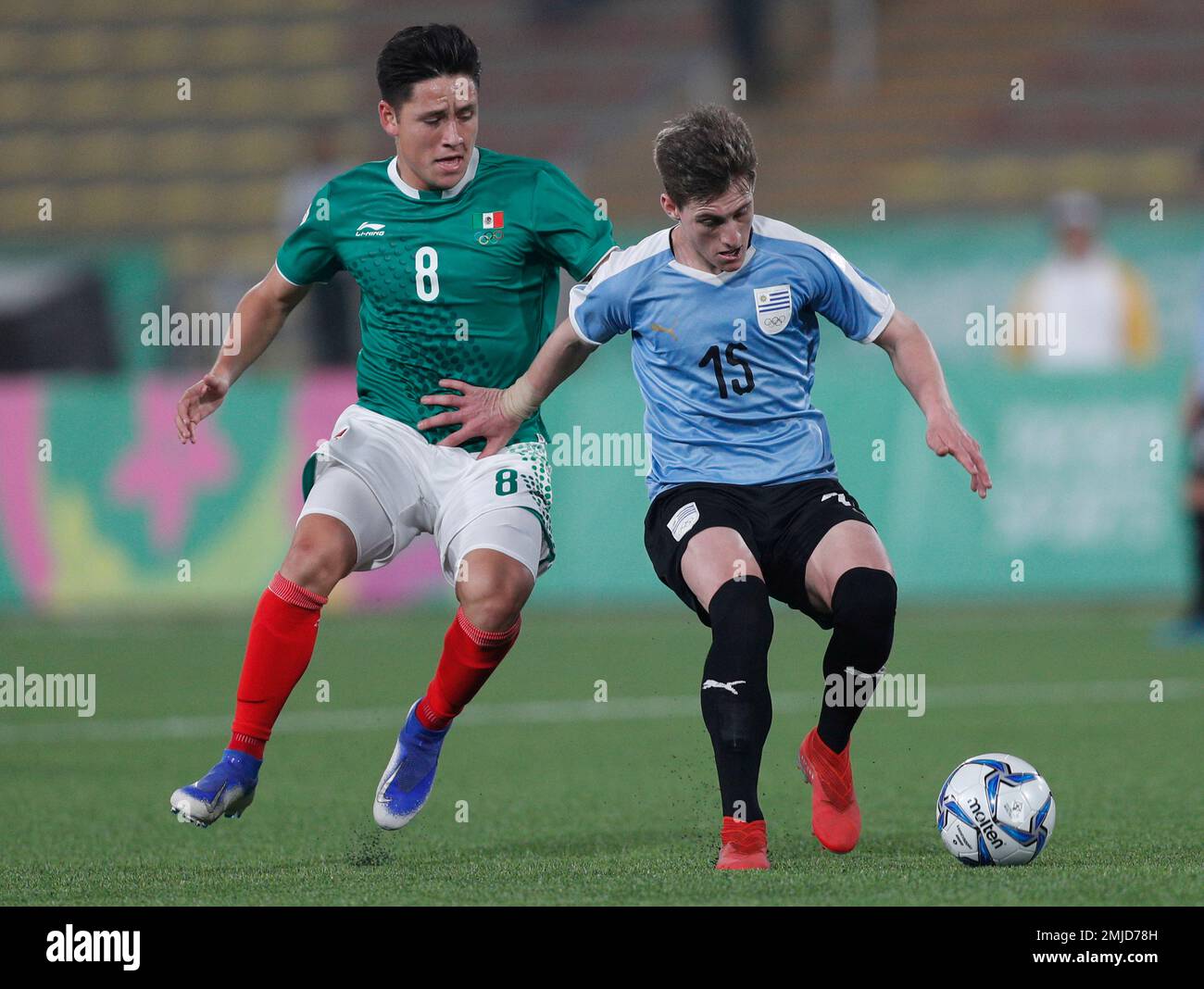 Facundo Waller of Uruguay, right, controls the ball under pressure from ...