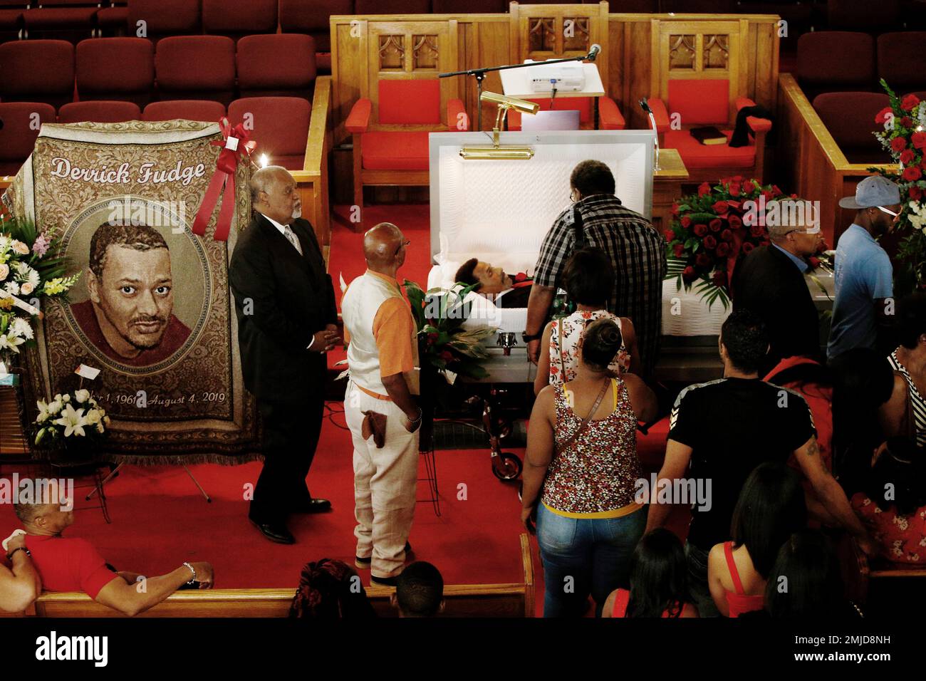Friends and family mourn Derrick Fudge on Saturday, Aug. 10, 2019, at a ...