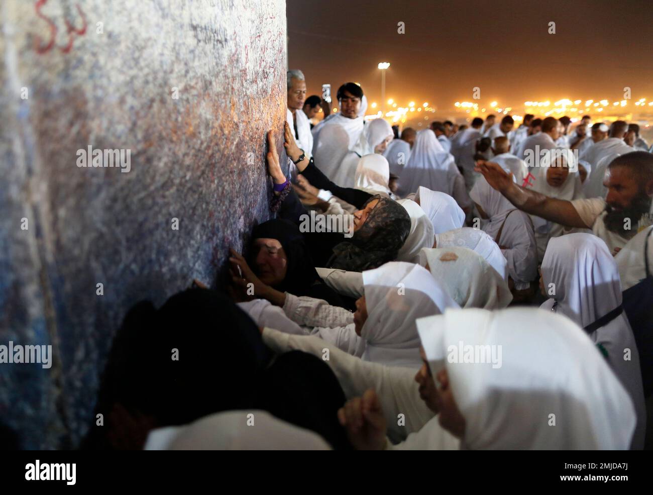 Muslim pilgrims pray in front of a pillar, where Islam's Prophet ...