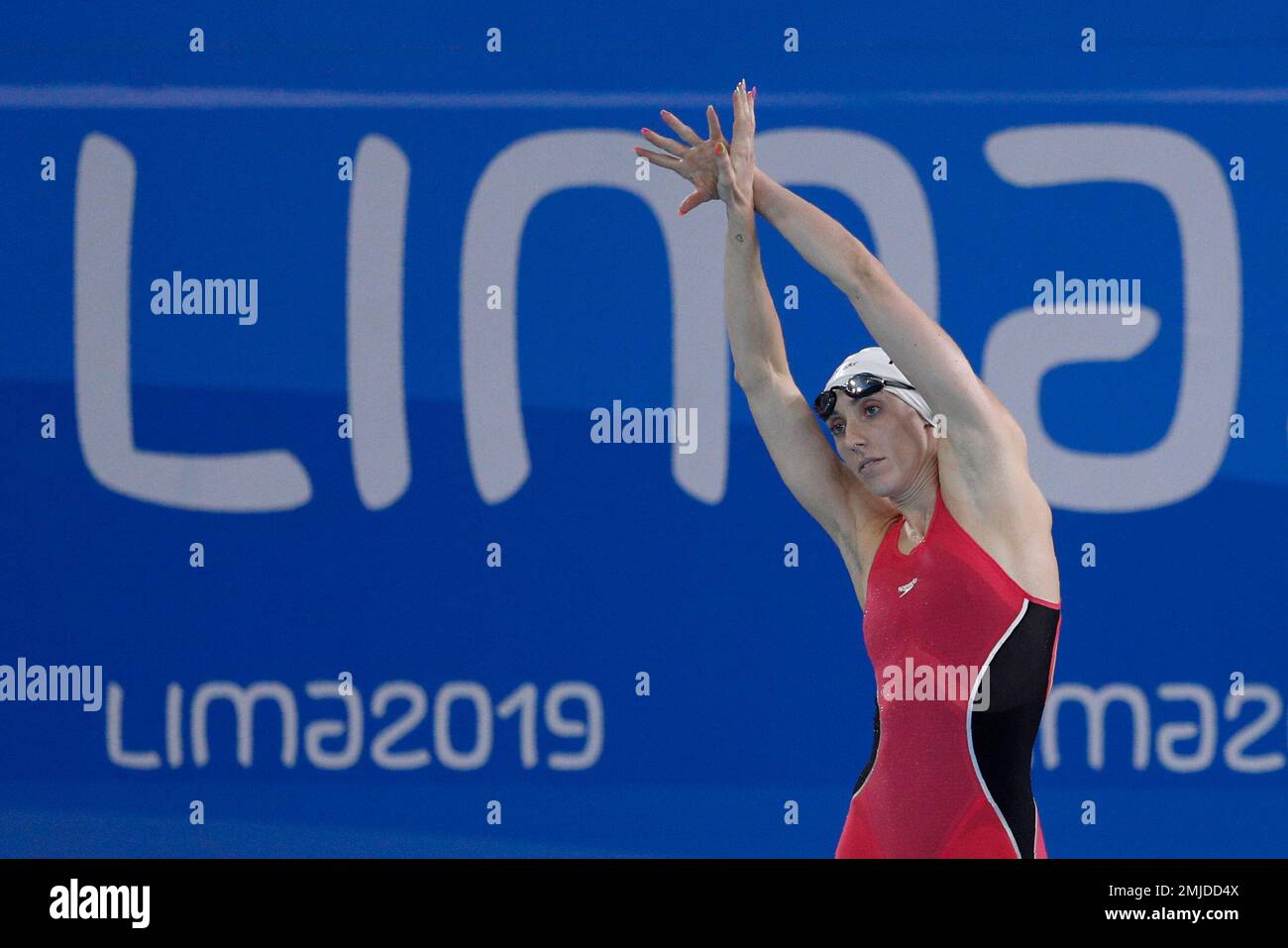 Madison Kennedy of the U.S. stretches as she prepares to compete in a ...