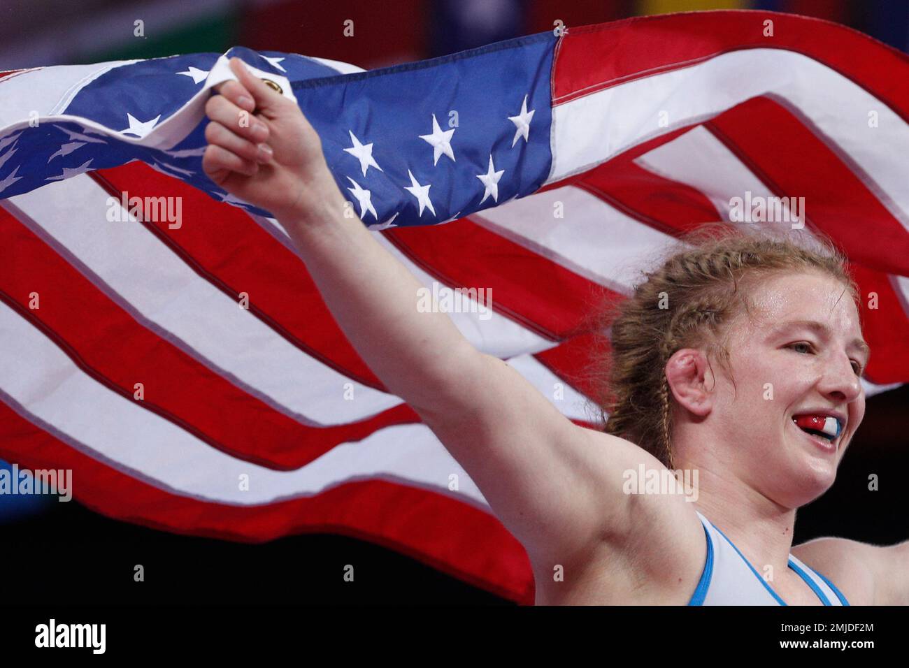 Whitney Conder of the U.S. runs with an American flag as she celebrates ...