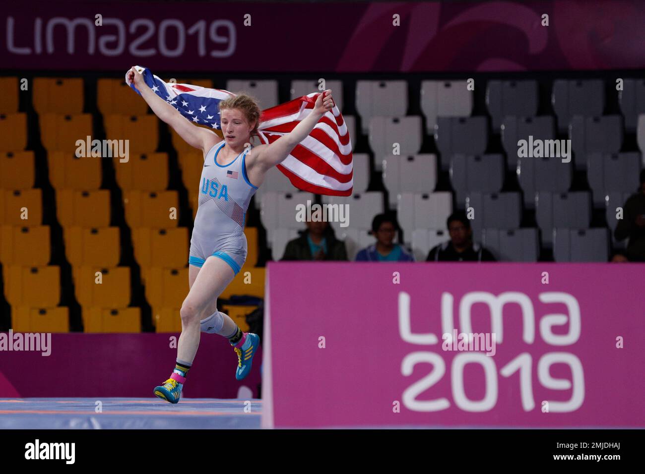 Whitney Conder of the U.S. runs with an American flag as she celebrates ...