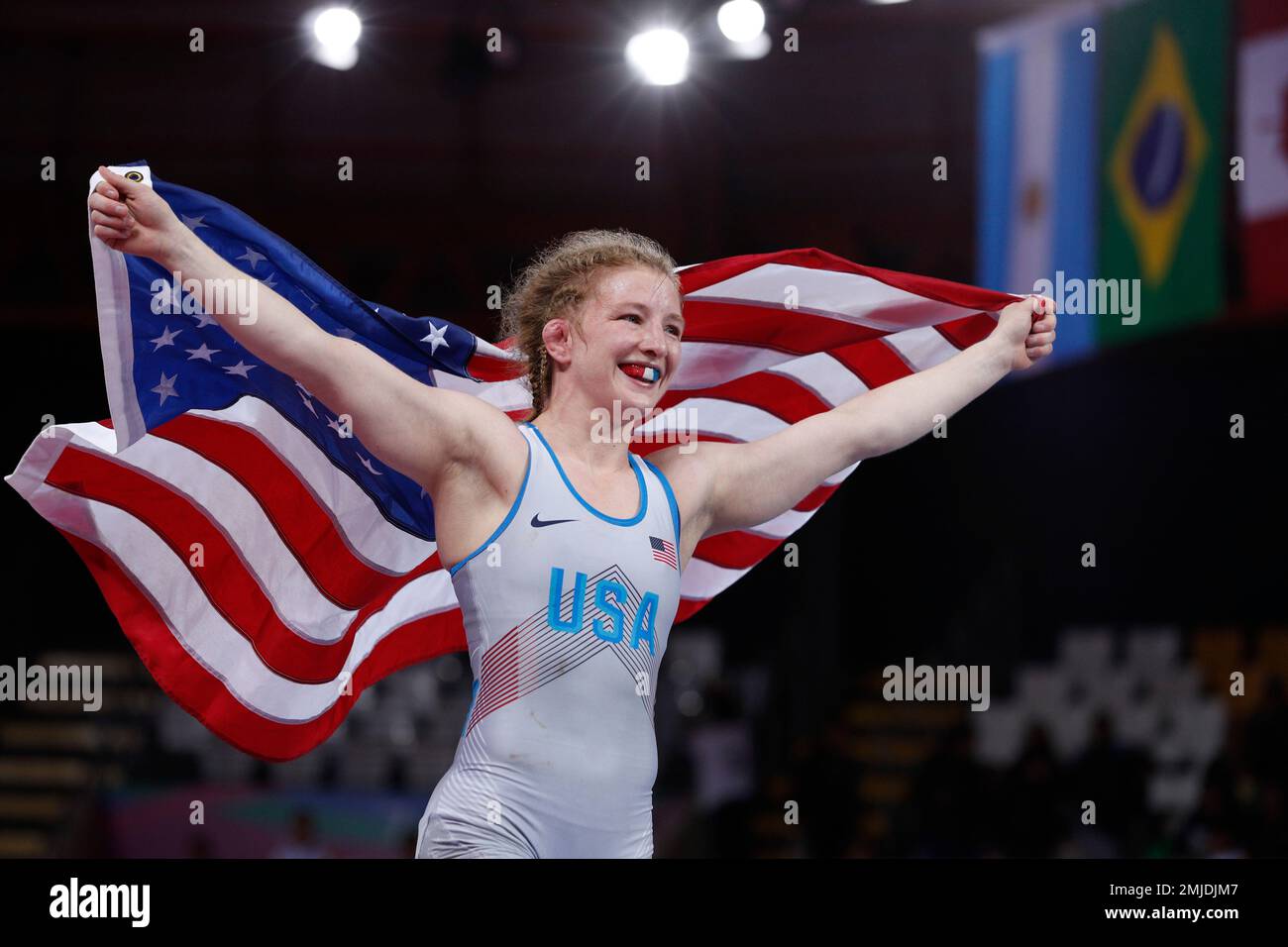 Whitney Conder of the U.S. runs with an American flag as she celebrates ...