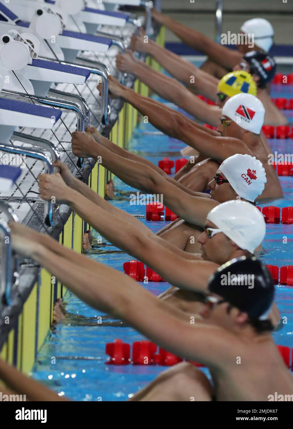 Athletes compete in the men's swimming 100m backstroke at the Pan ...