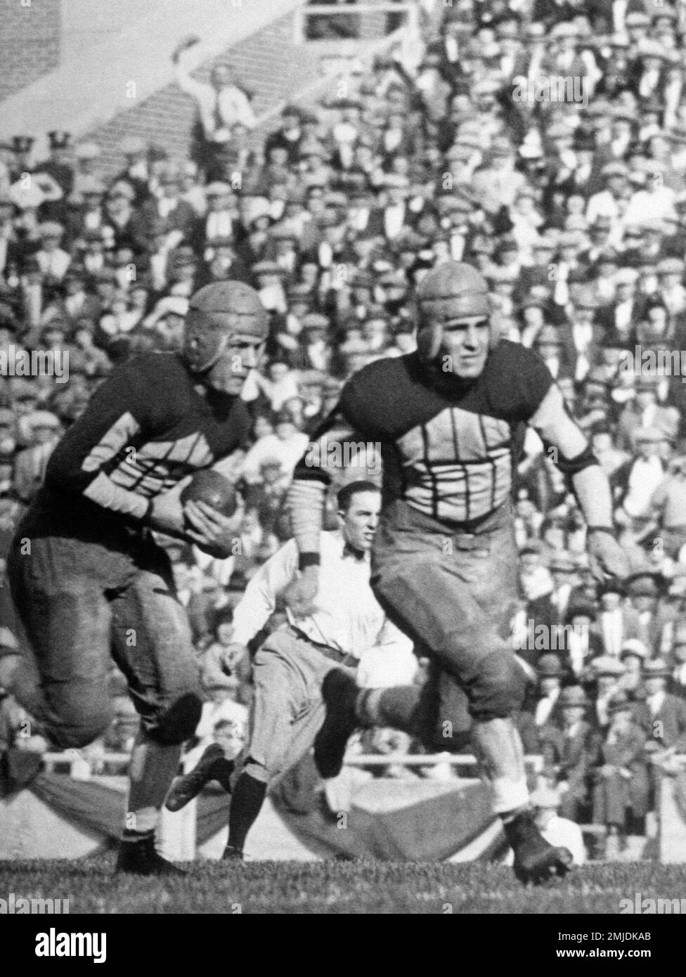 FILE - In this 1924 file photo, Illinois' Red Grange, left, follows a ...