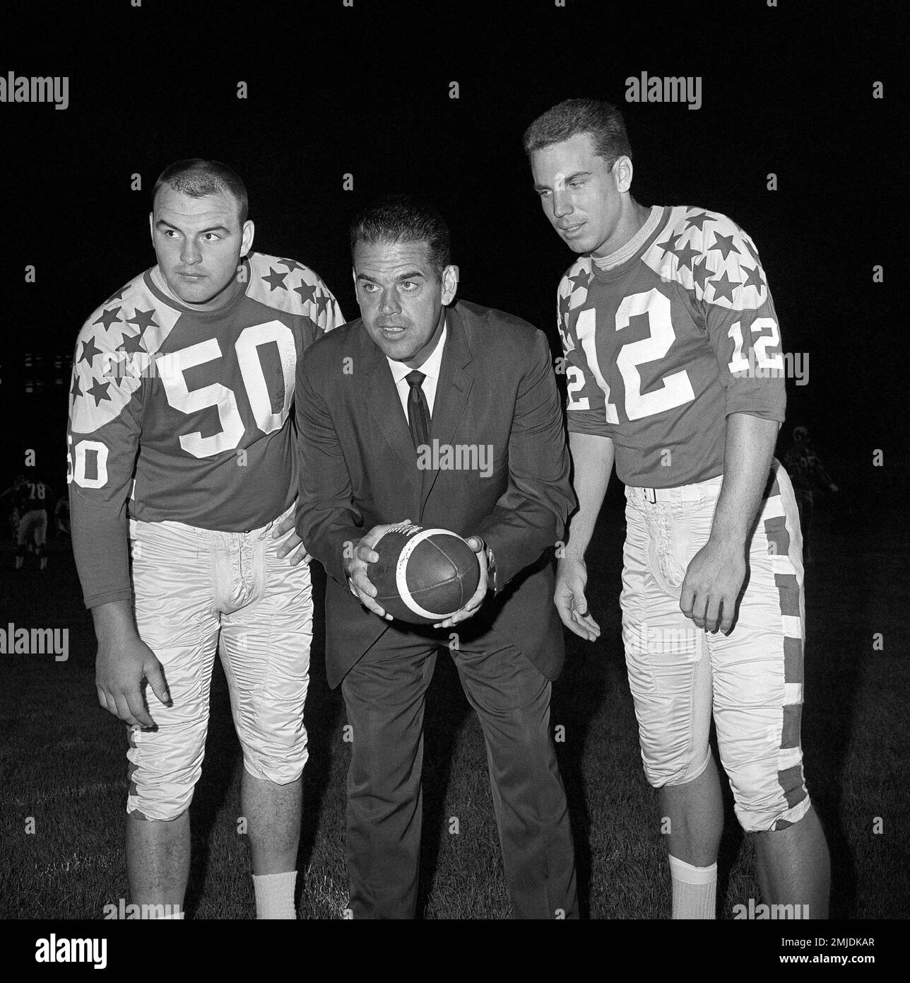 FILE - In this Aug. 5, 1965, file photo, Otto Graham, center, coach of the College All Stars ...