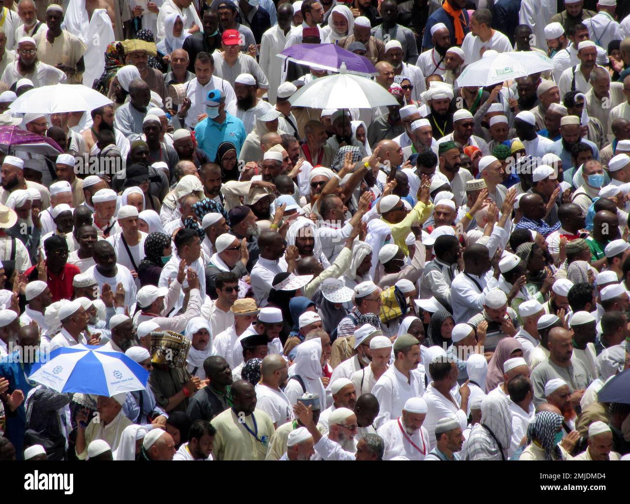 Muslim pilgrims circumambulate around the Kaaba, the cubic building at ...