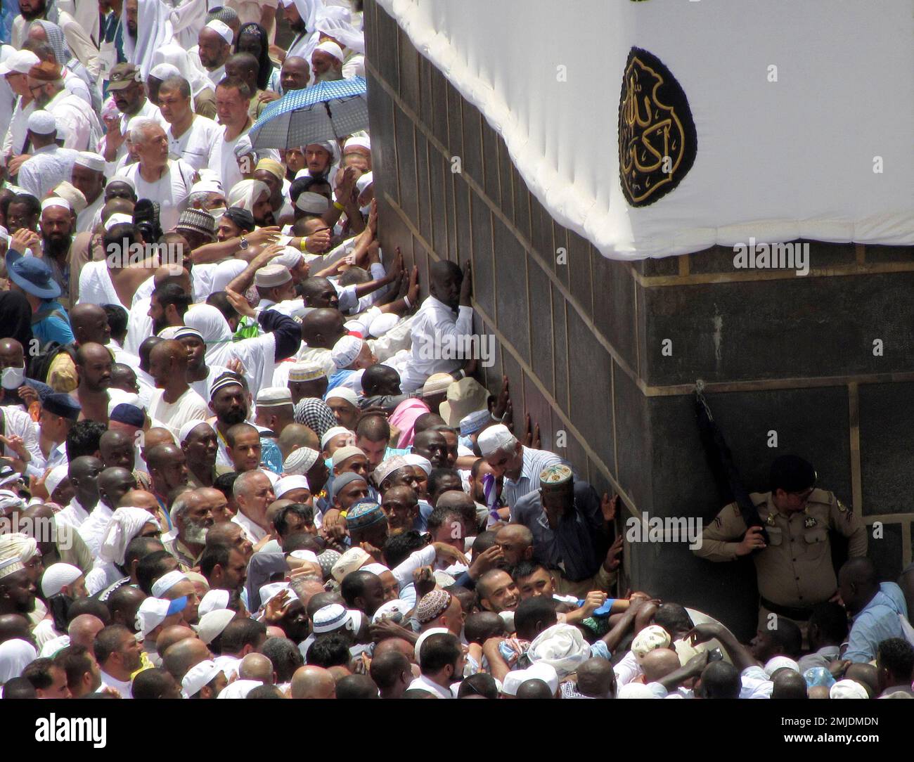 Muslim pilgrims circumambulate around the Kaaba, the cubic building at ...