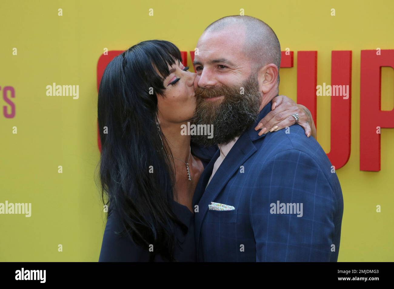 Michael Tiddes, right, smiles as his wife gives him a kiss as they ...