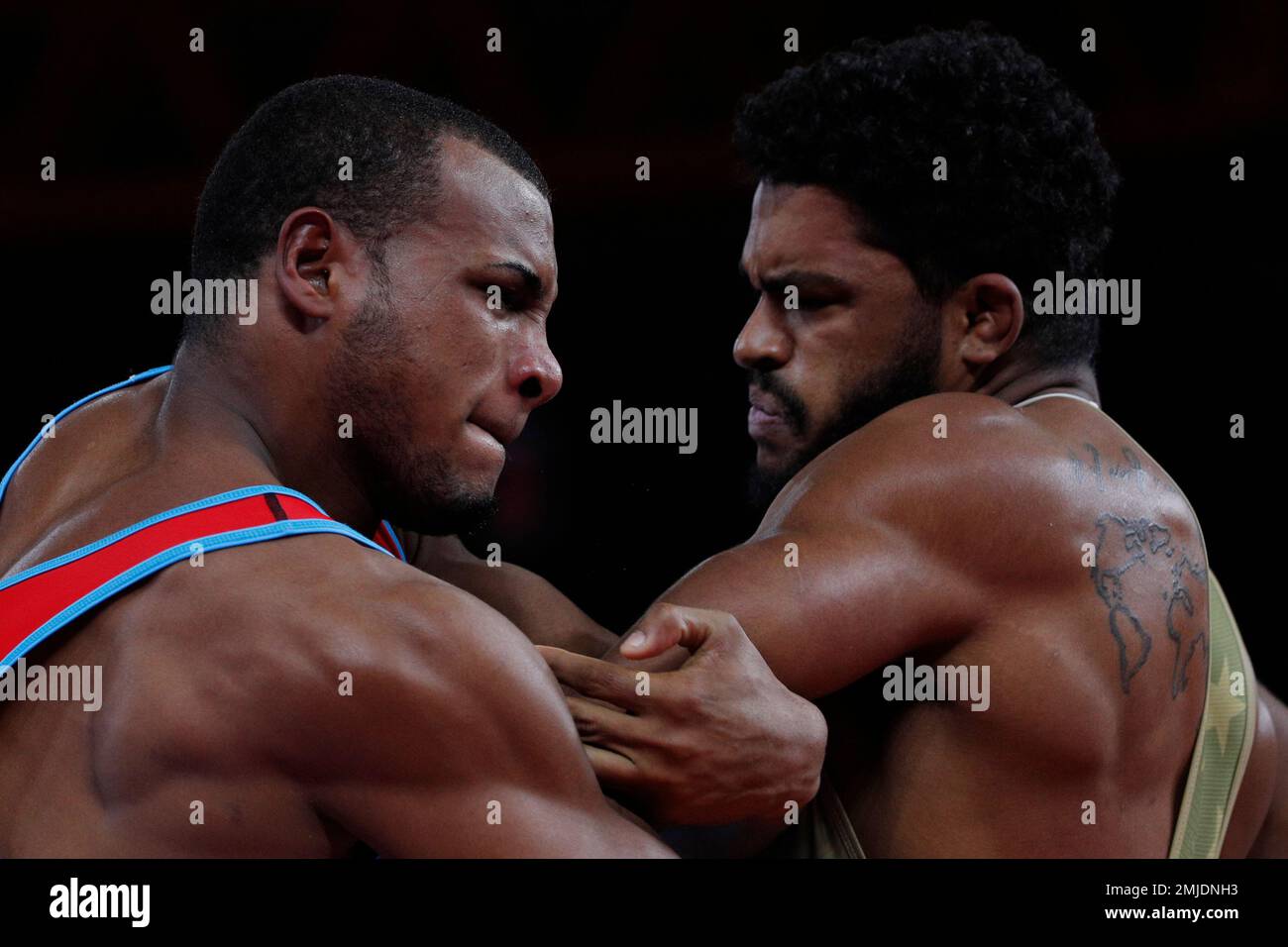 Cuba's Gabriel Rosillo, left, struggles with Tracy Hancock of the U.S ...