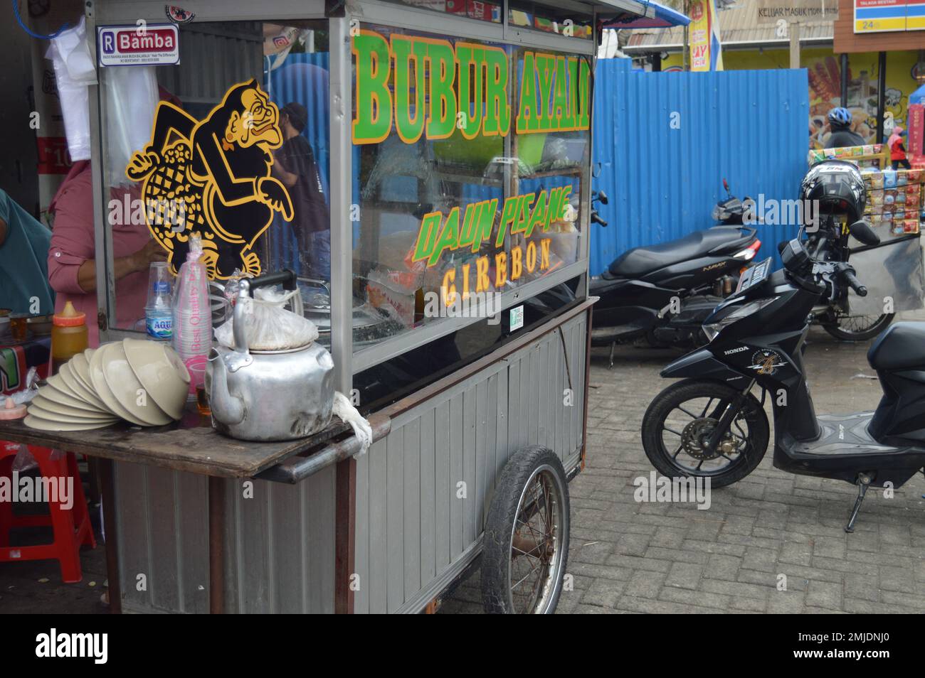 A portrait of a chicken porridge seller's display case with an ...