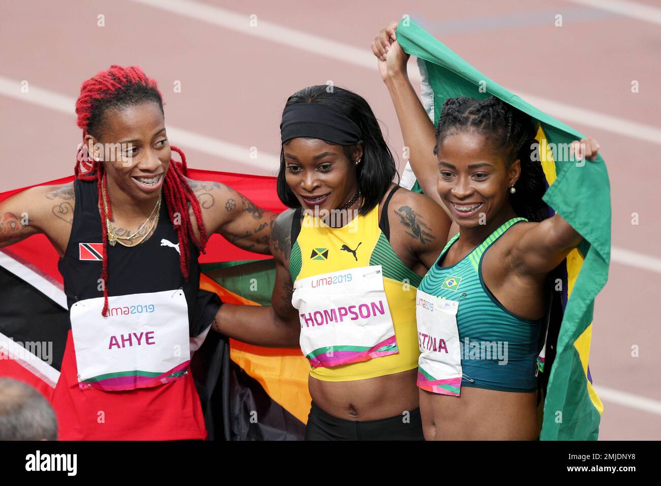 The gold medalist Elaine Thompson of Jamaica, center, silver medalist Michelle-Lee Ahye of ...