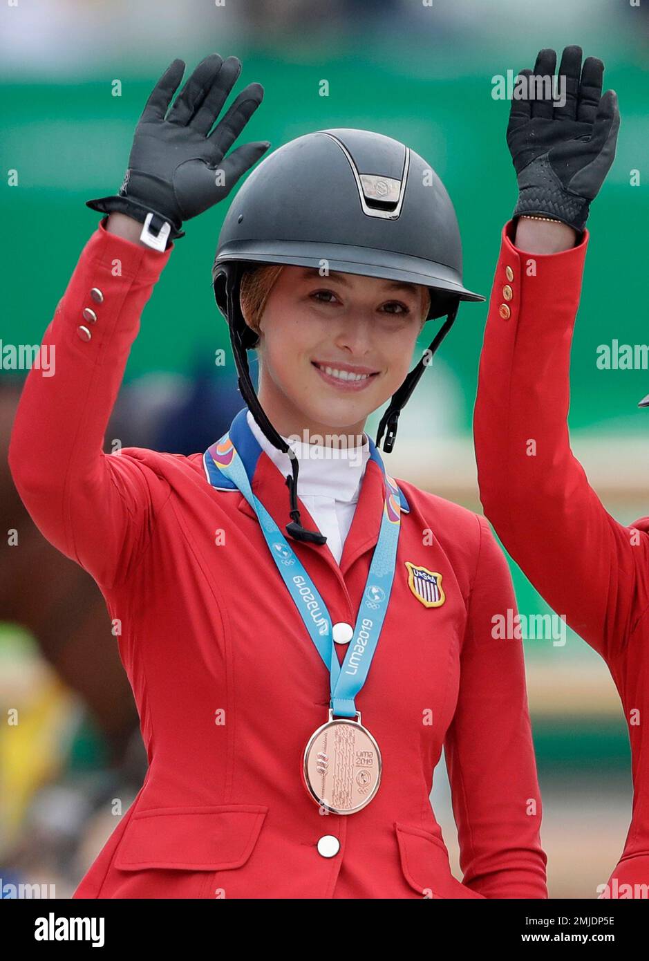 Bronze medalist Eve Jobs of the United States waves during the medal ...