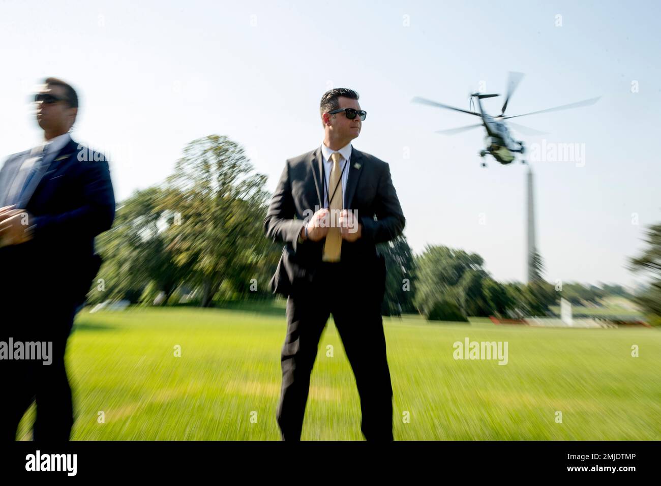 Secret Service agents stand guard as Marine One, with President Donald ...