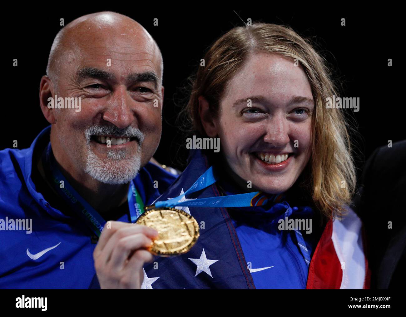 Anne-Elizabeth Stone of the U.S. holds up her gold medal for women's ...
